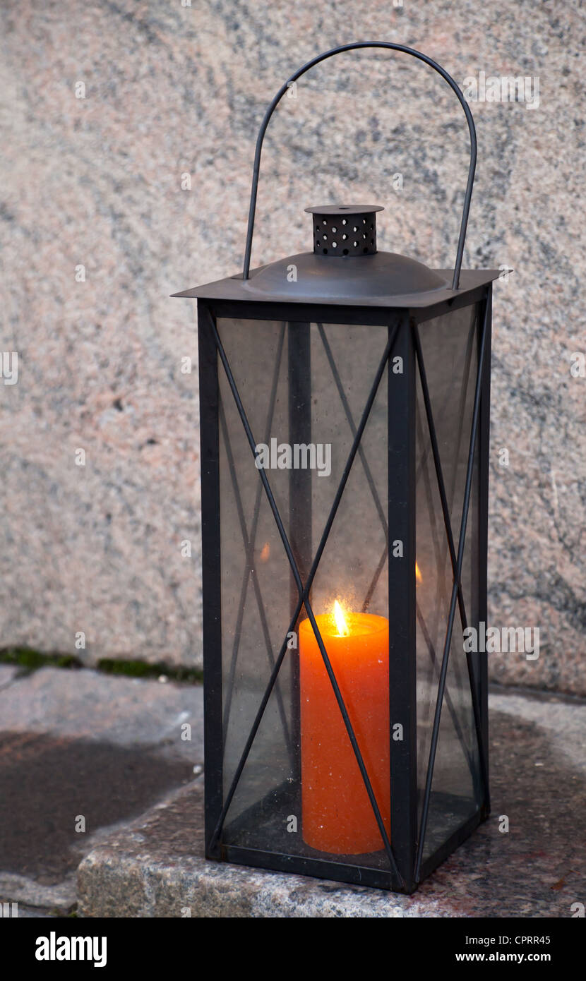 Old black metal vintage lamp with red candle inside Stock Photo - Alamy