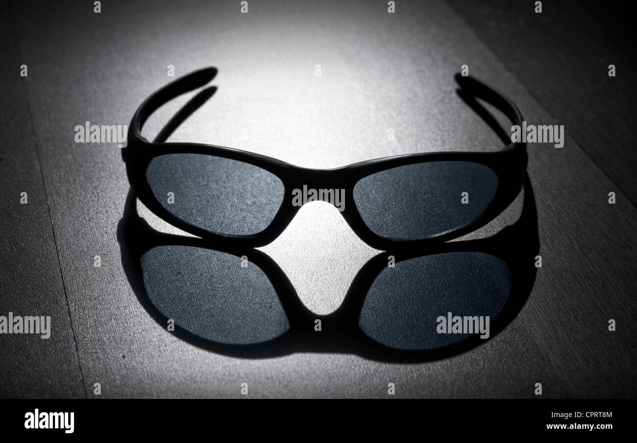 Monochrome photo of black modern sun glasses with back sun light and ...