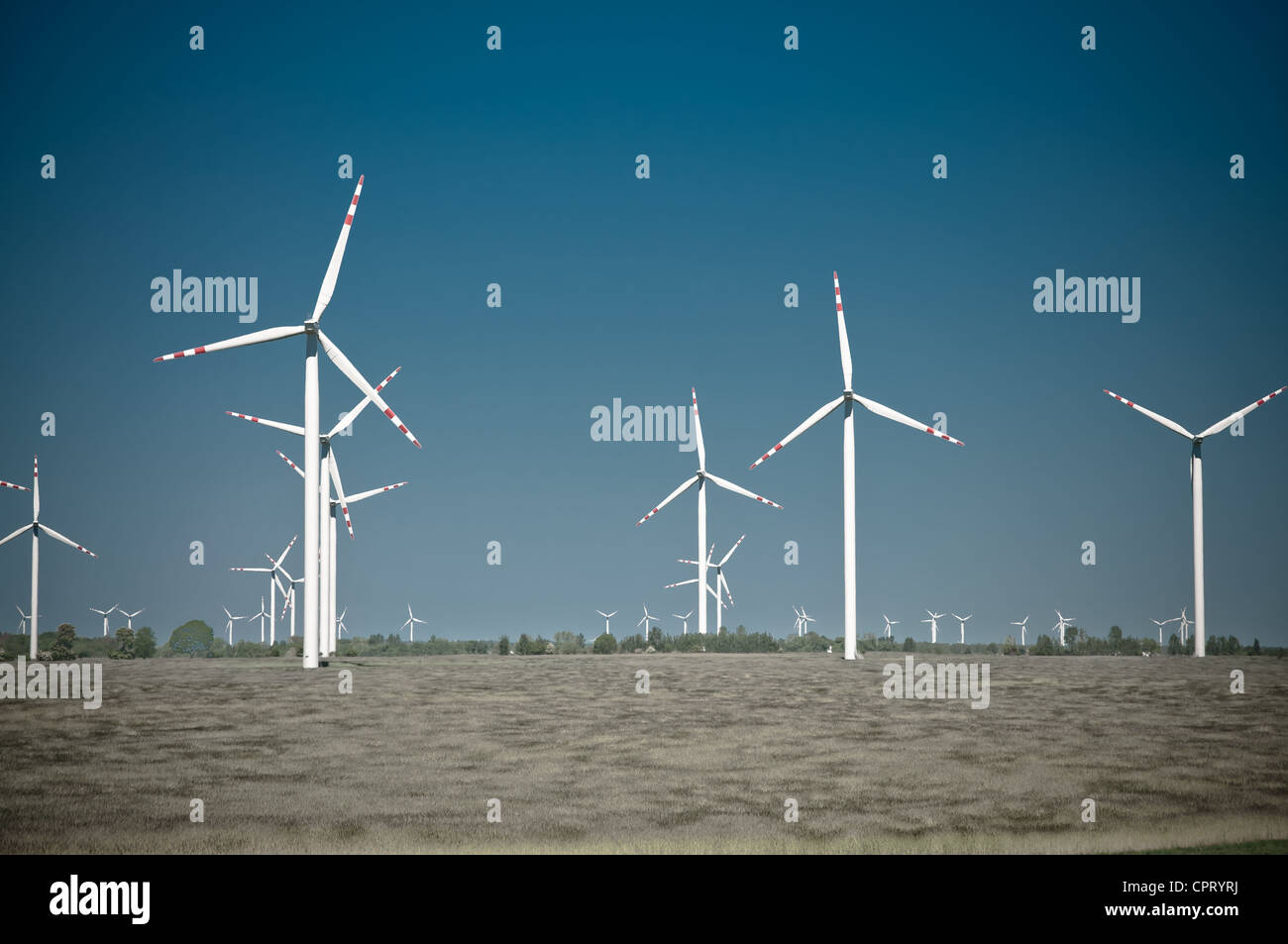 Wind turbine farm on rural terrain Stock Photo - Alamy