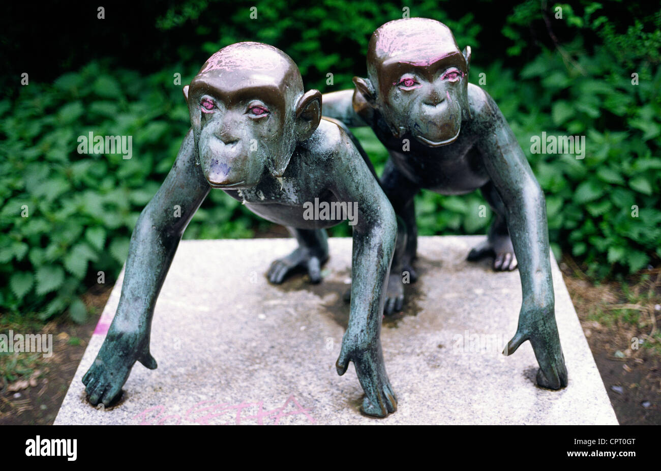 Small bronze statue of monkeys with their eyes painted red in a Berlin ...