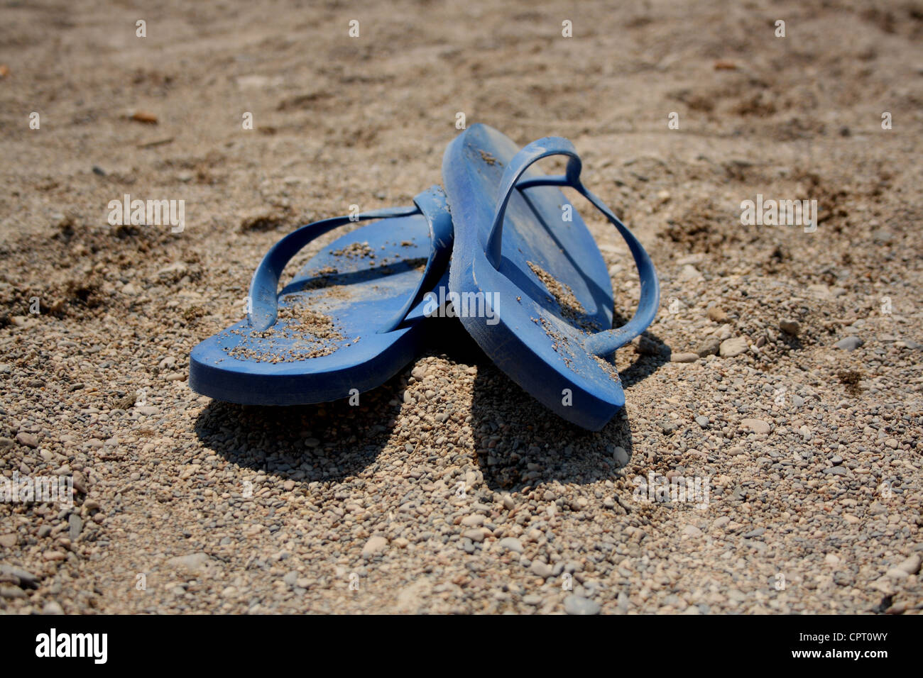 Sandals on a beach Stock Photo - Alamy