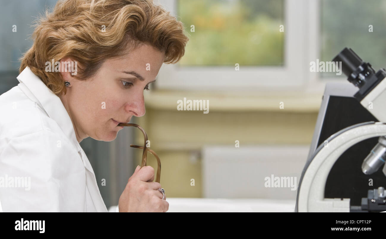 Female researcher thinking at his workplace Stock Photo - Alamy