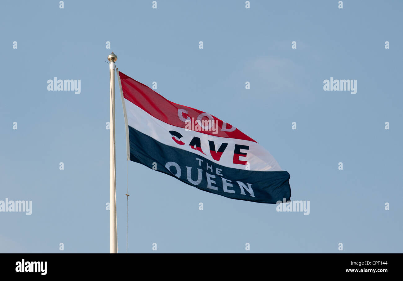A red white and blue God Save the Queen flag flying from a flagpole on ...