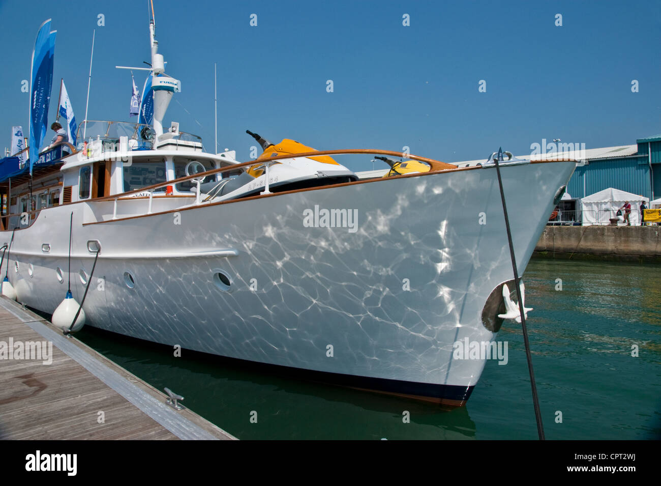 The front and side of a small boat with the water reflected on the ...