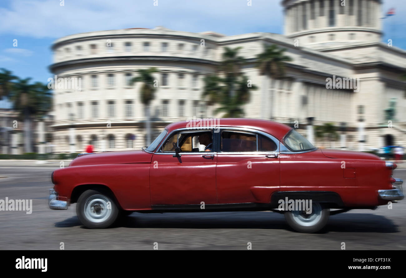 Red American fifties car in front of the Capitolio Nacional Old Havana ...