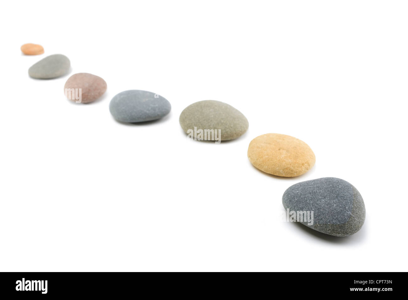 Rounded stones arranged in a curving line on white background Stock ...