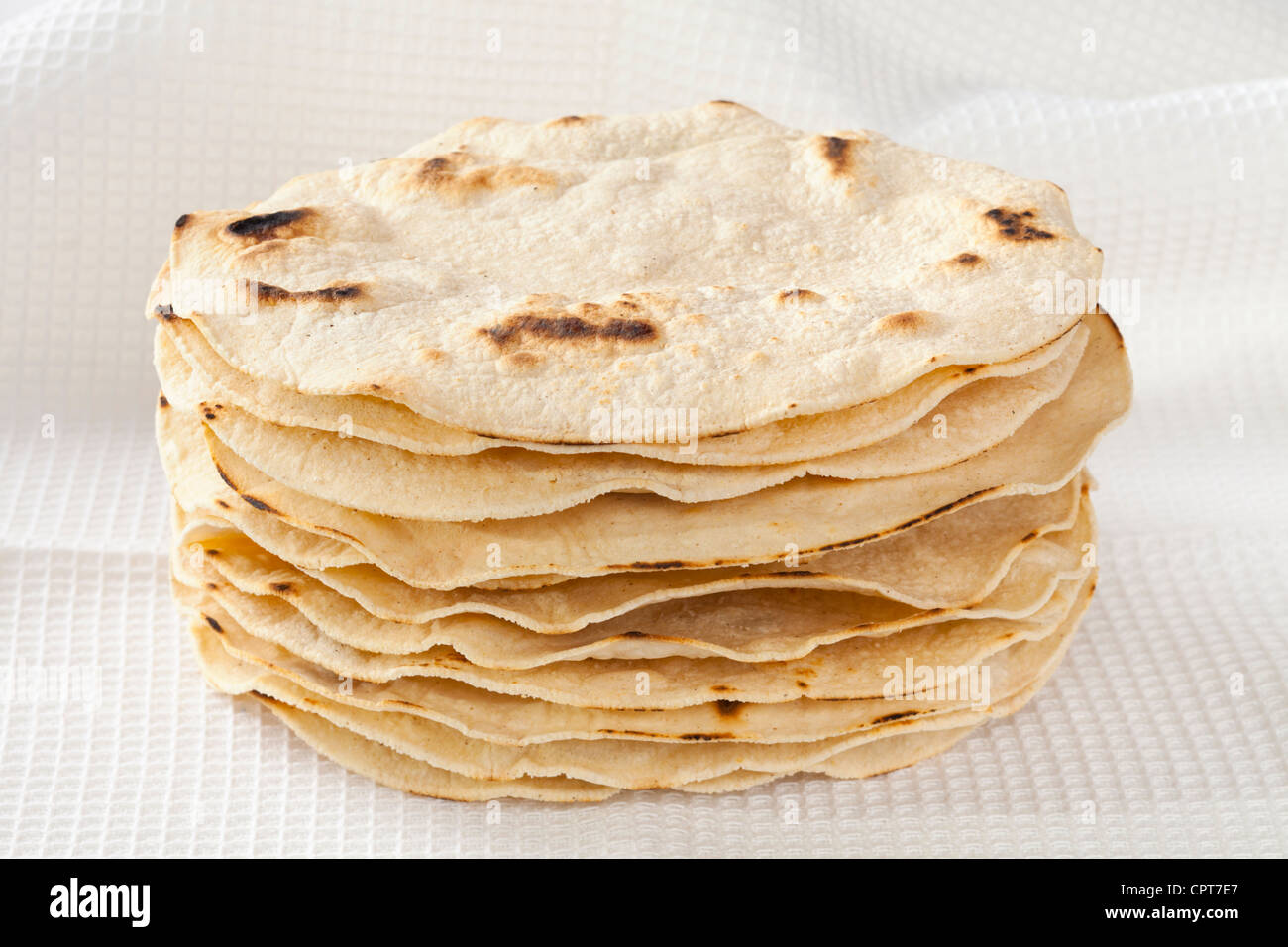 Stack of fresh corn tortillas in a white cloth Stock Photo - Alamy