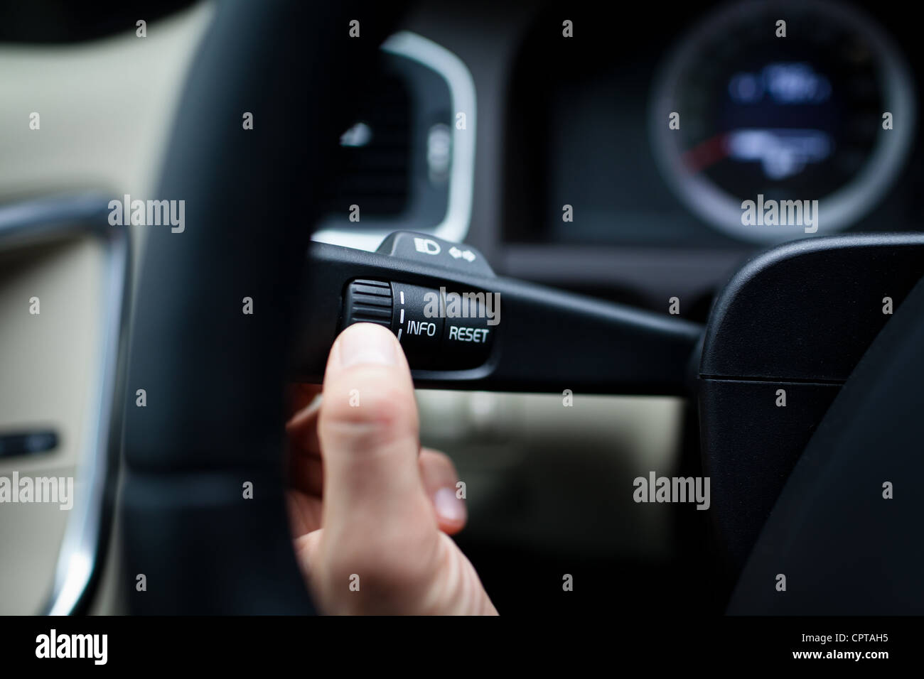 Modern car interior - driver pressing a button, using the car computer ...