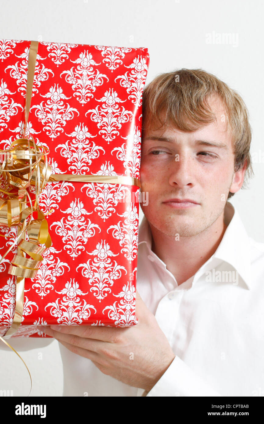 A man trying to guess a present Stock Photo - Alamy
