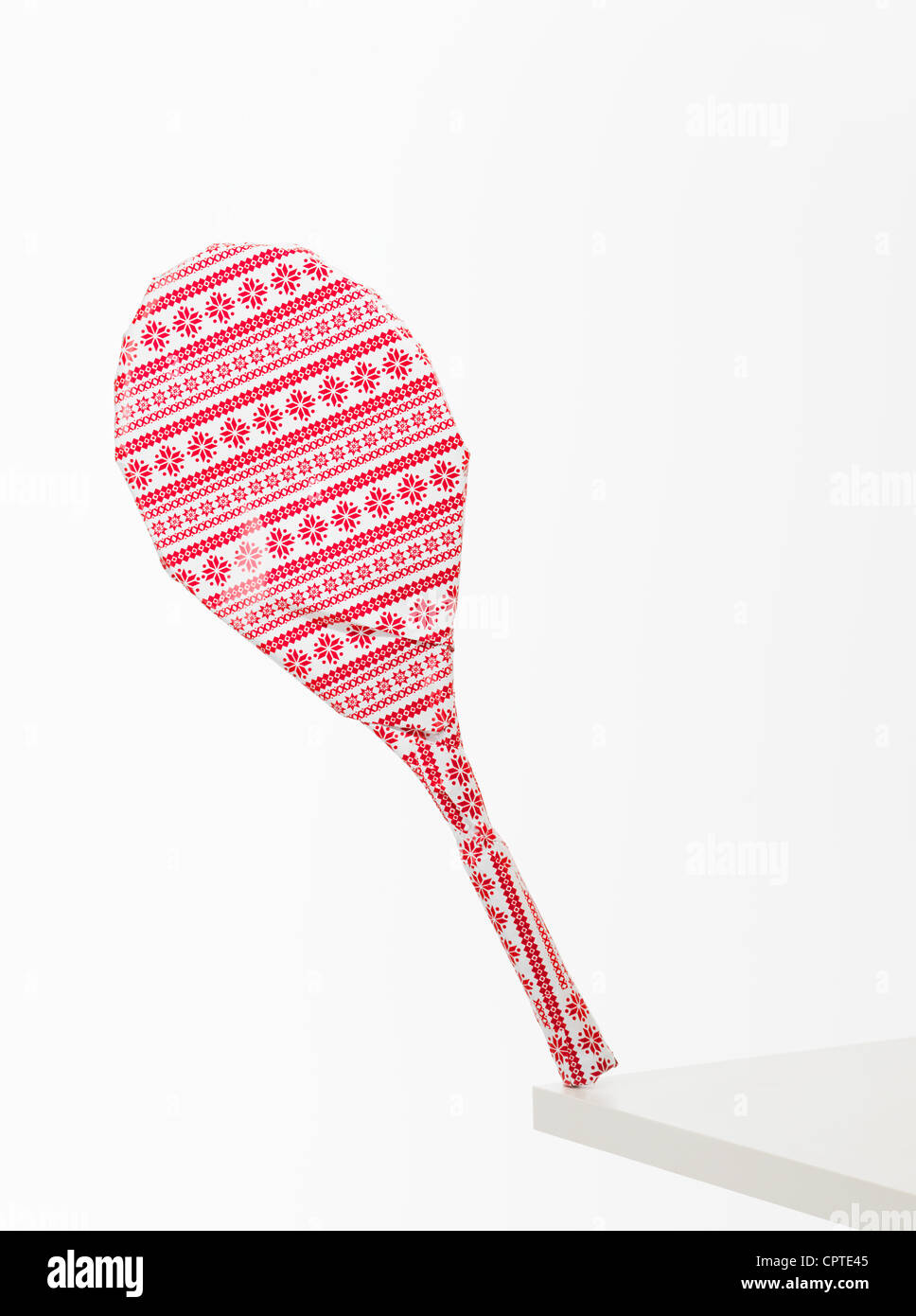 Gift wrapped tennis racket against white background Stock Photo - Alamy