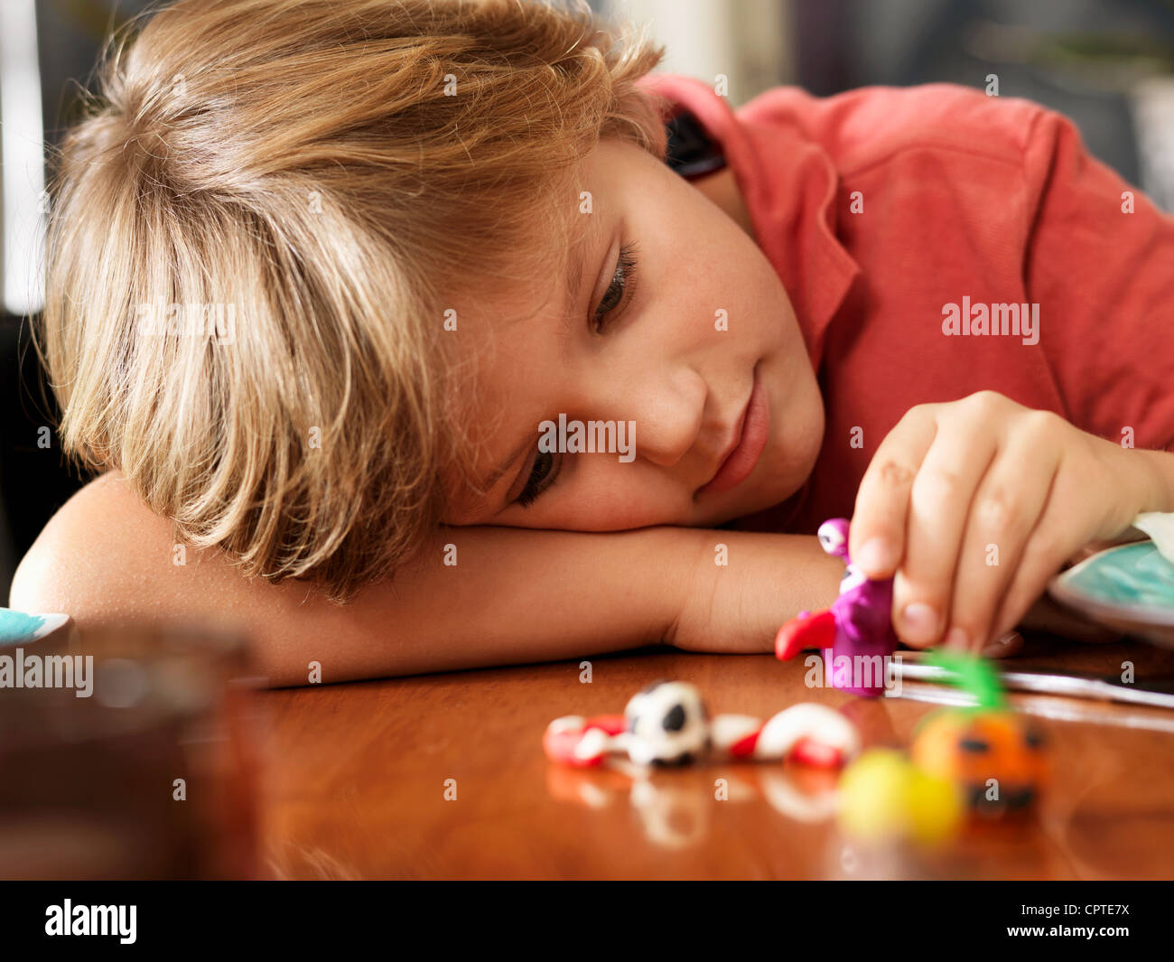 Boy playing with toys on table Stock Photo - Alamy