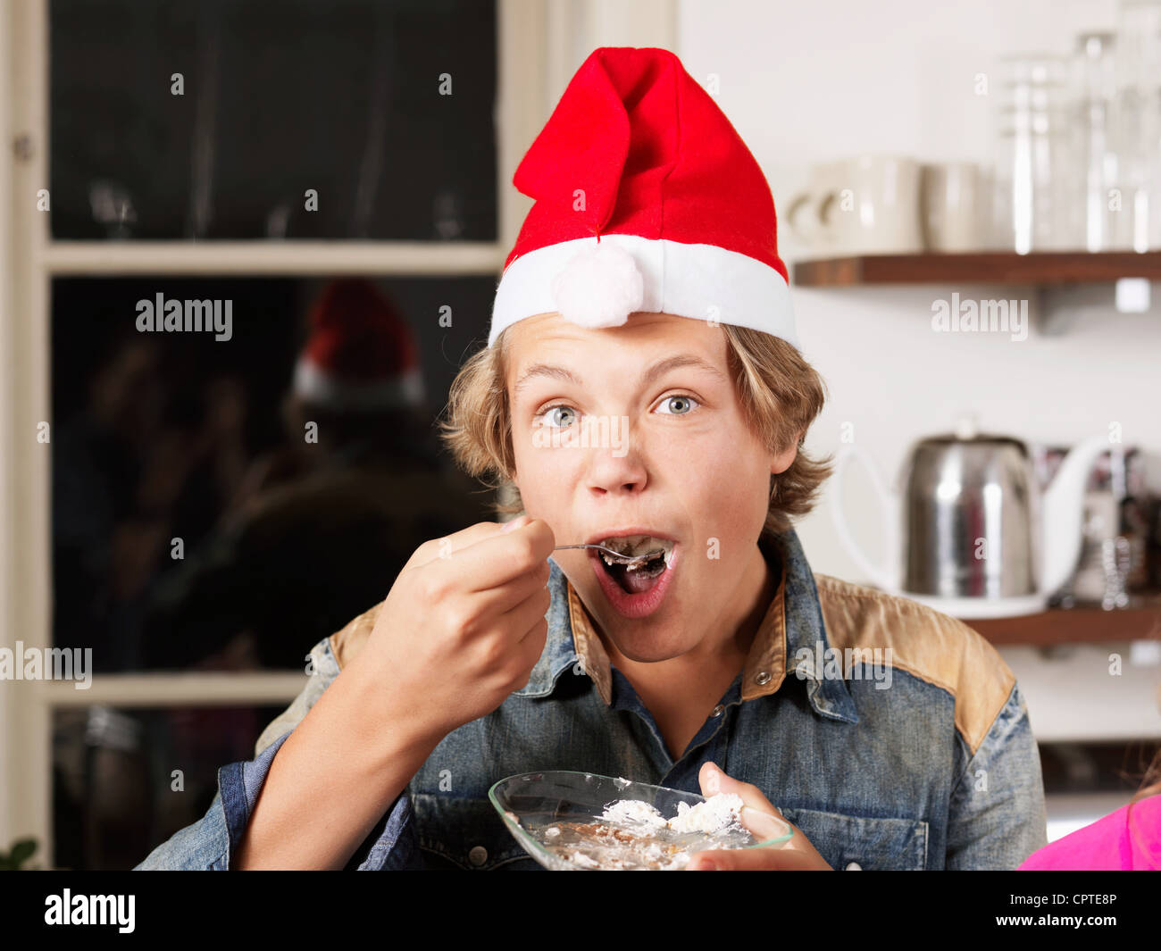 Boy wearing santa hat eating hi-res stock photography and images - Alamy