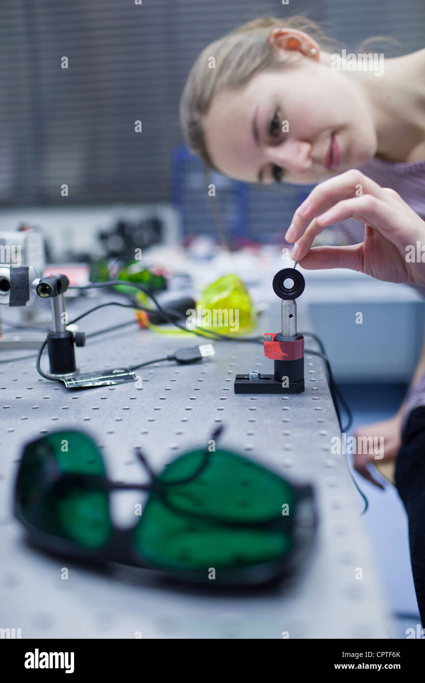 female scientist doing research in a quantum optics lab (color toned ...