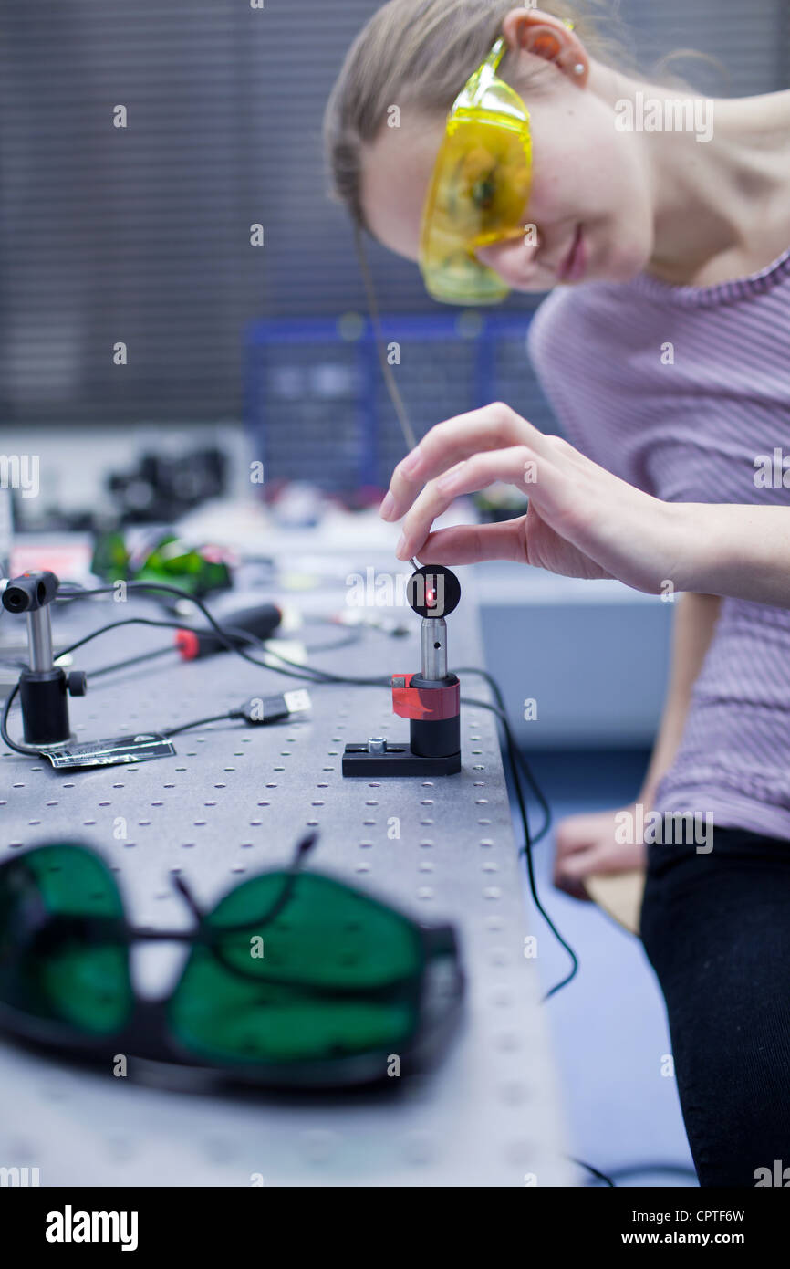 female scientist doing research in a quantum optics lab (color toned ...
