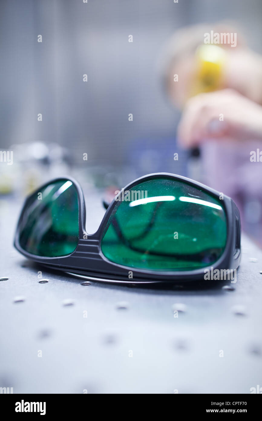 female scientist doing research in a quantum optics lab (color toned ...