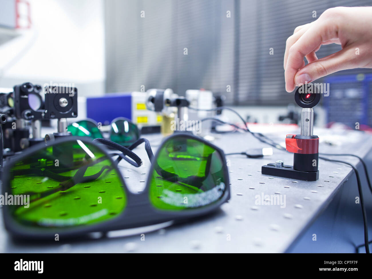 female scientist doing research in a quantum optics lab (color toned ...