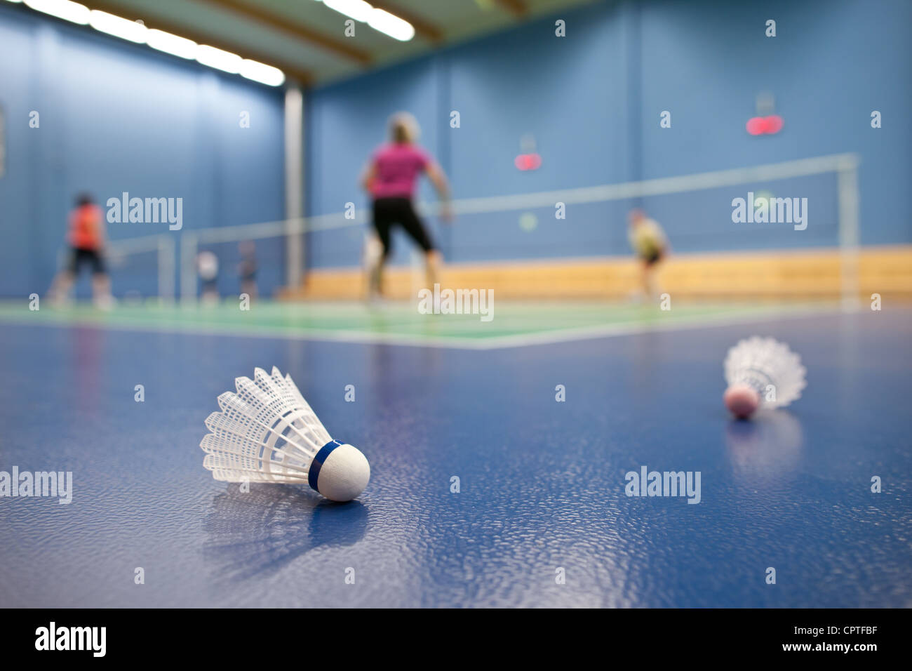 badminton - badminton courts with players competing; shuttlecocks in ...