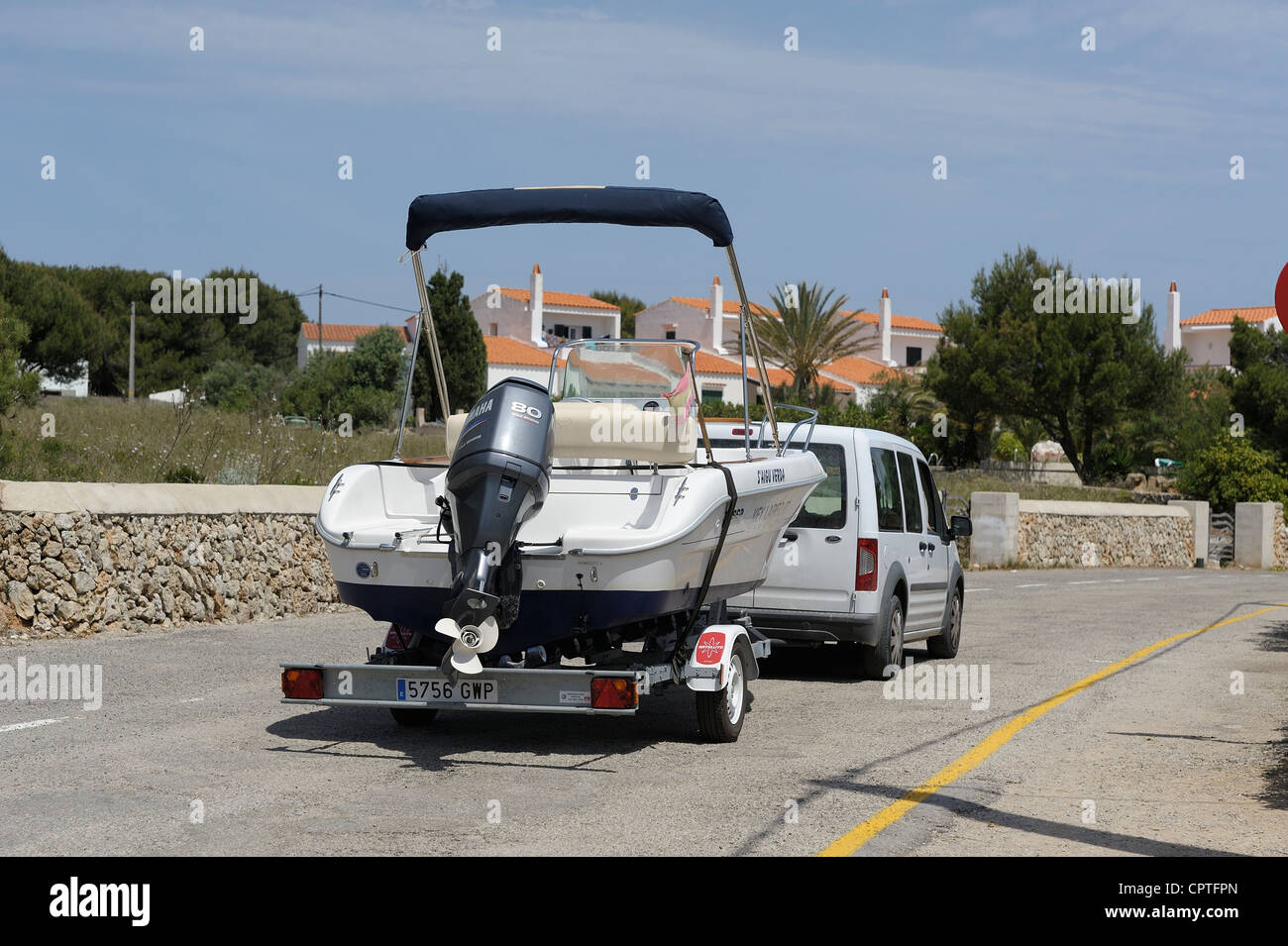 a speedboat on a trailer being towed through na macaret menorca spain ...