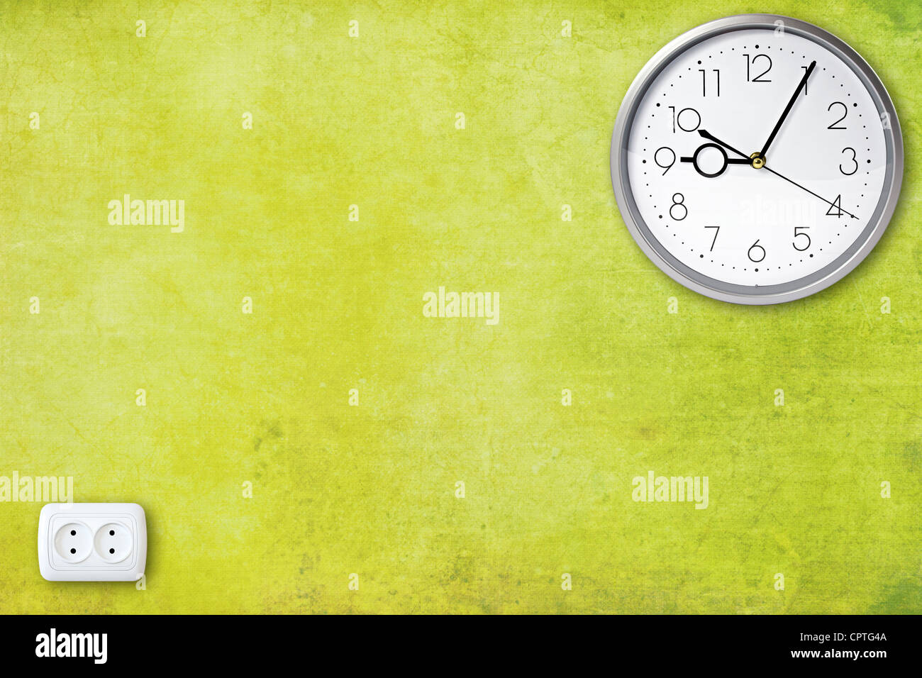 electric socket and clock on the green wall Stock Photo - Alamy