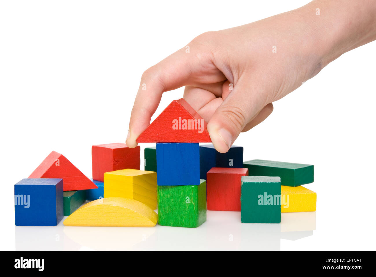 hand make a building of colored blocks. isolated on white Stock Photo ...