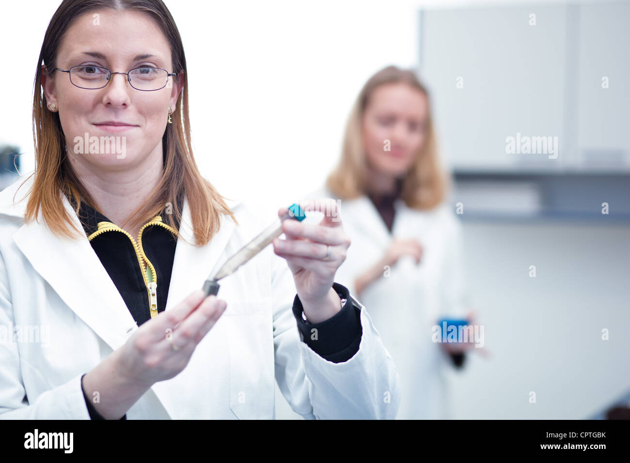 Two female researchers carrying out research in a chemistry ...