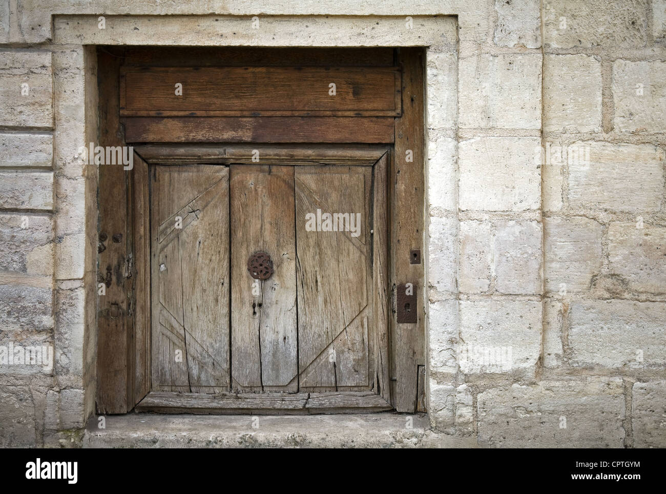 Stone wall of an ancient building with old weathered wooden gate Stock ...