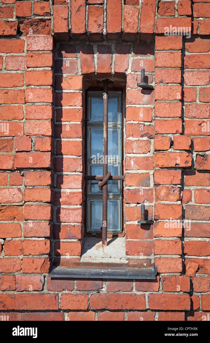 Brick wall of an old building with small rectangle window Stock Photo ...