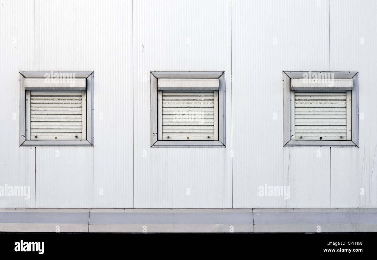Texture of industrial building wall with three closed rectangle windows ...