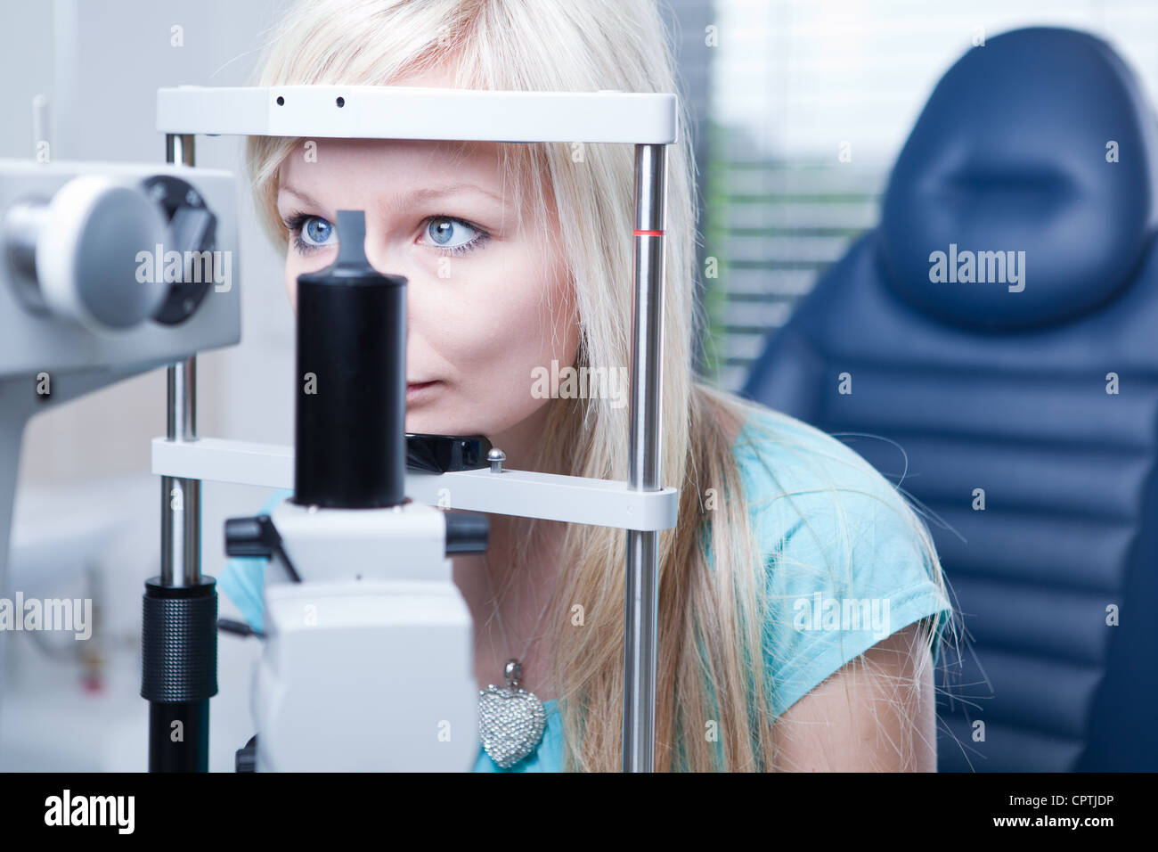 optometry concept - pretty young female patient having her eyes ...