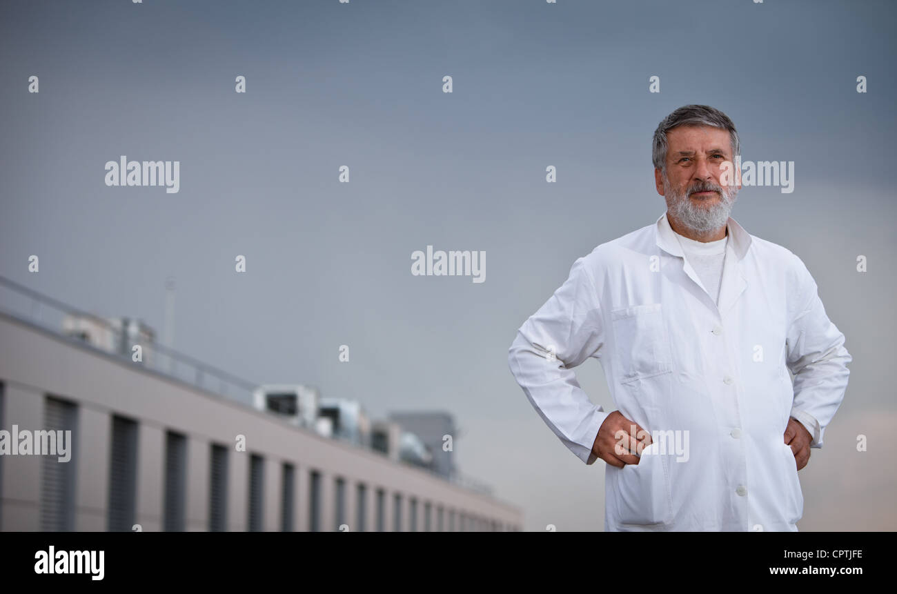 renowned scientist/doctor standing on the roof of the research center ...