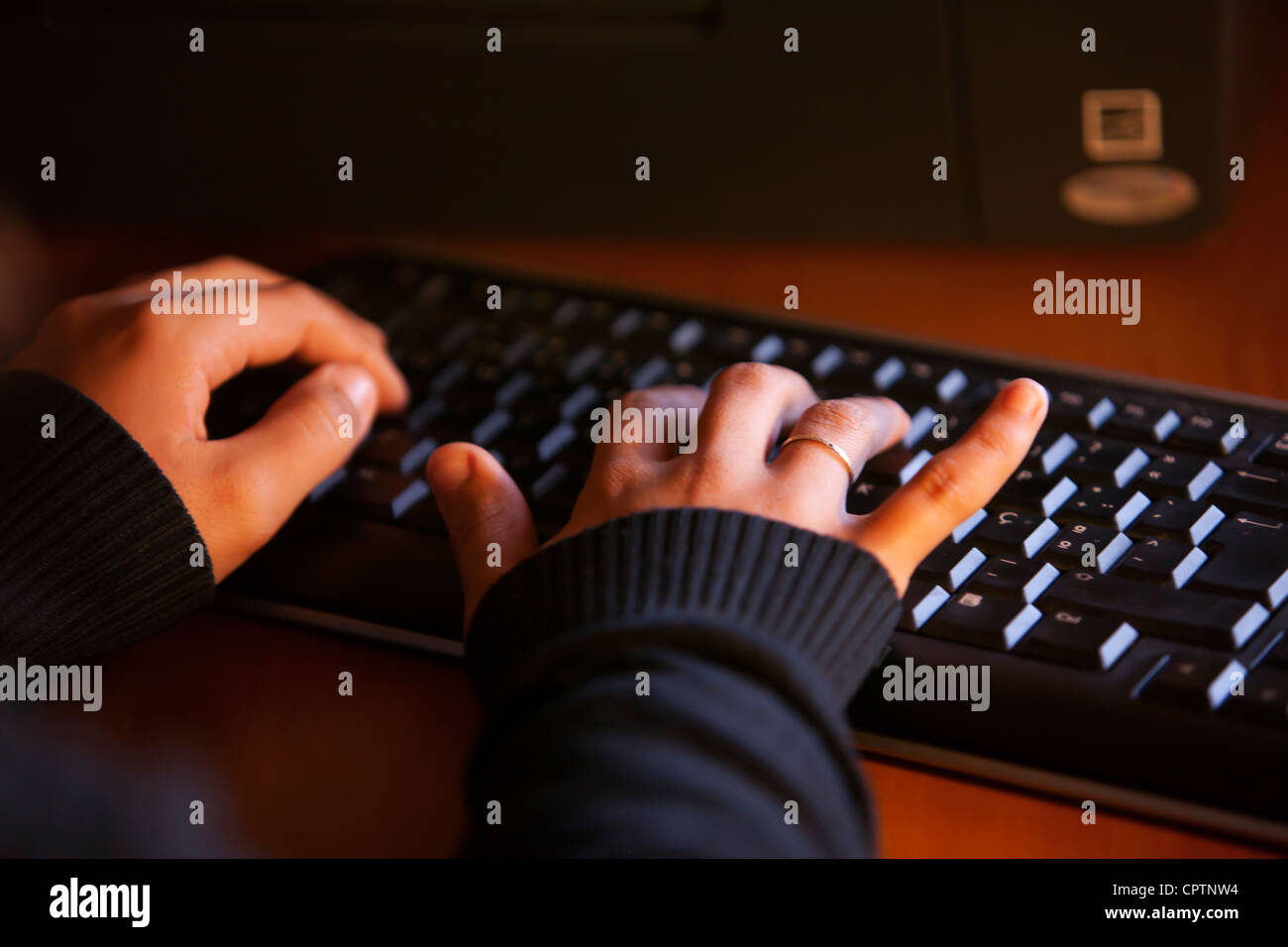 Young woman writing on a computer keyboard Stock Photo - Alamy