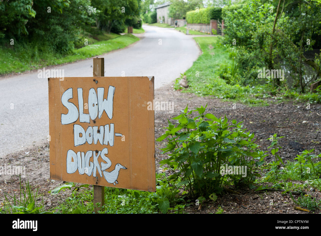 Slow down village road sign hi-res stock photography and images - Alamy