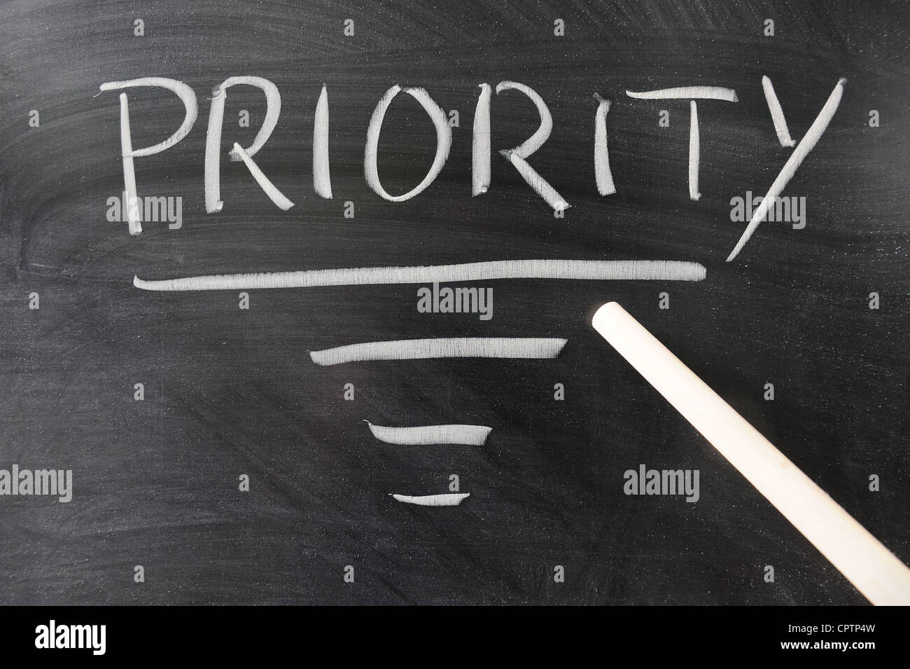 Pointer stick points to Priority word written on the blackboard Stock ...