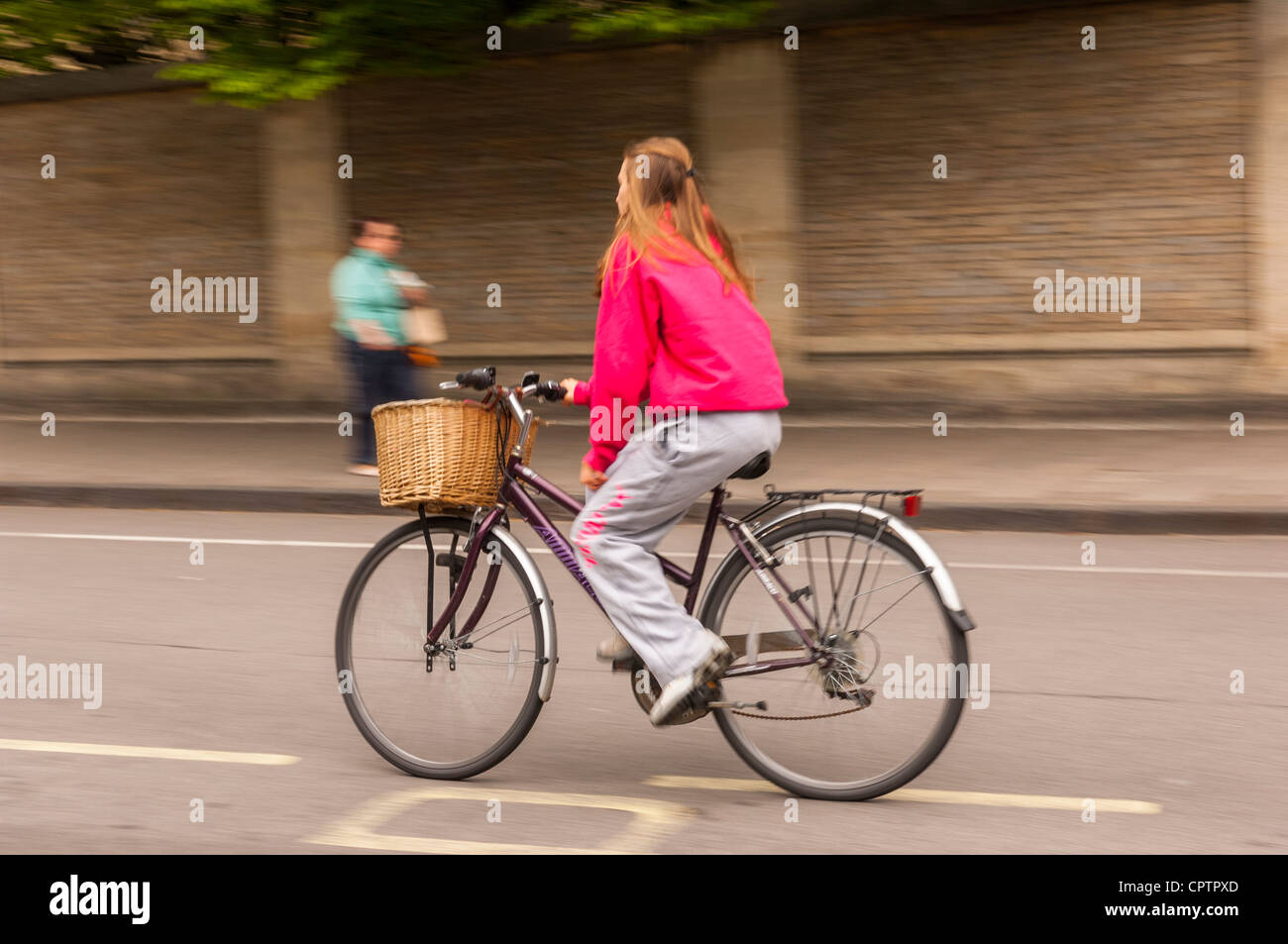 A girl cycling on a bike showing movement in Cambridge , England ...