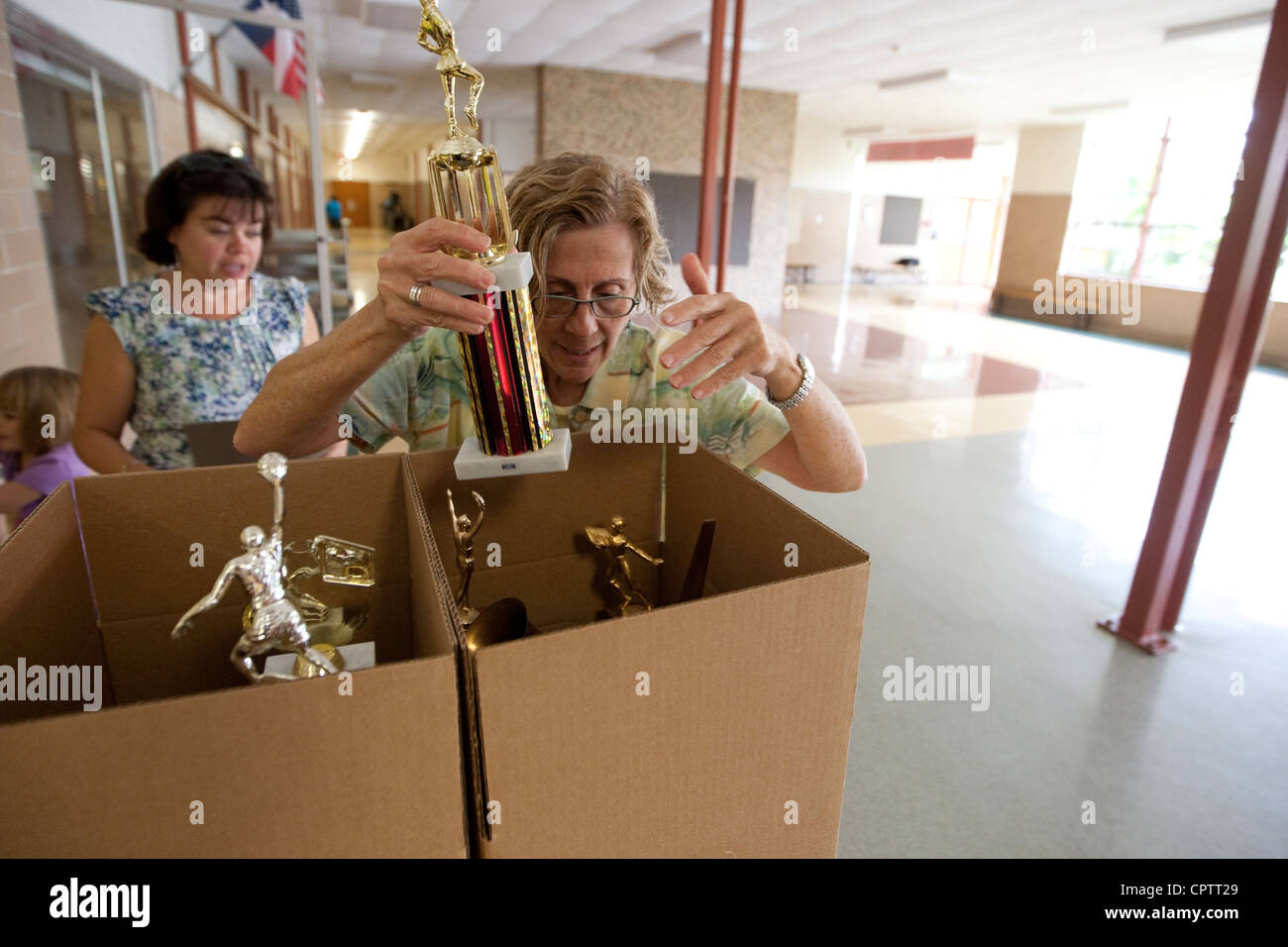 Teachers, students and librarians help pack up materials. The ...