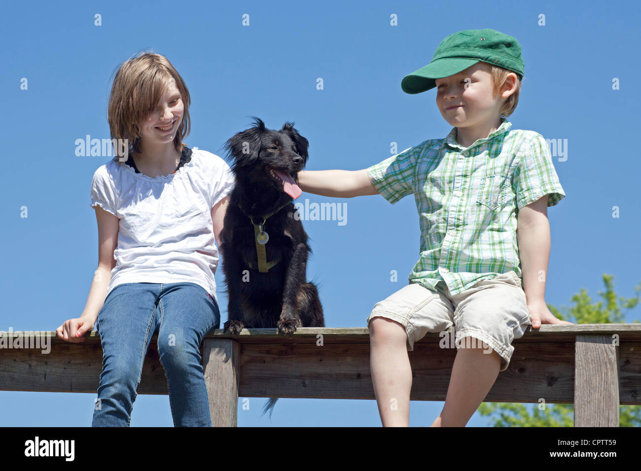 portrait of two children and their dog Stock Photo - Alamy