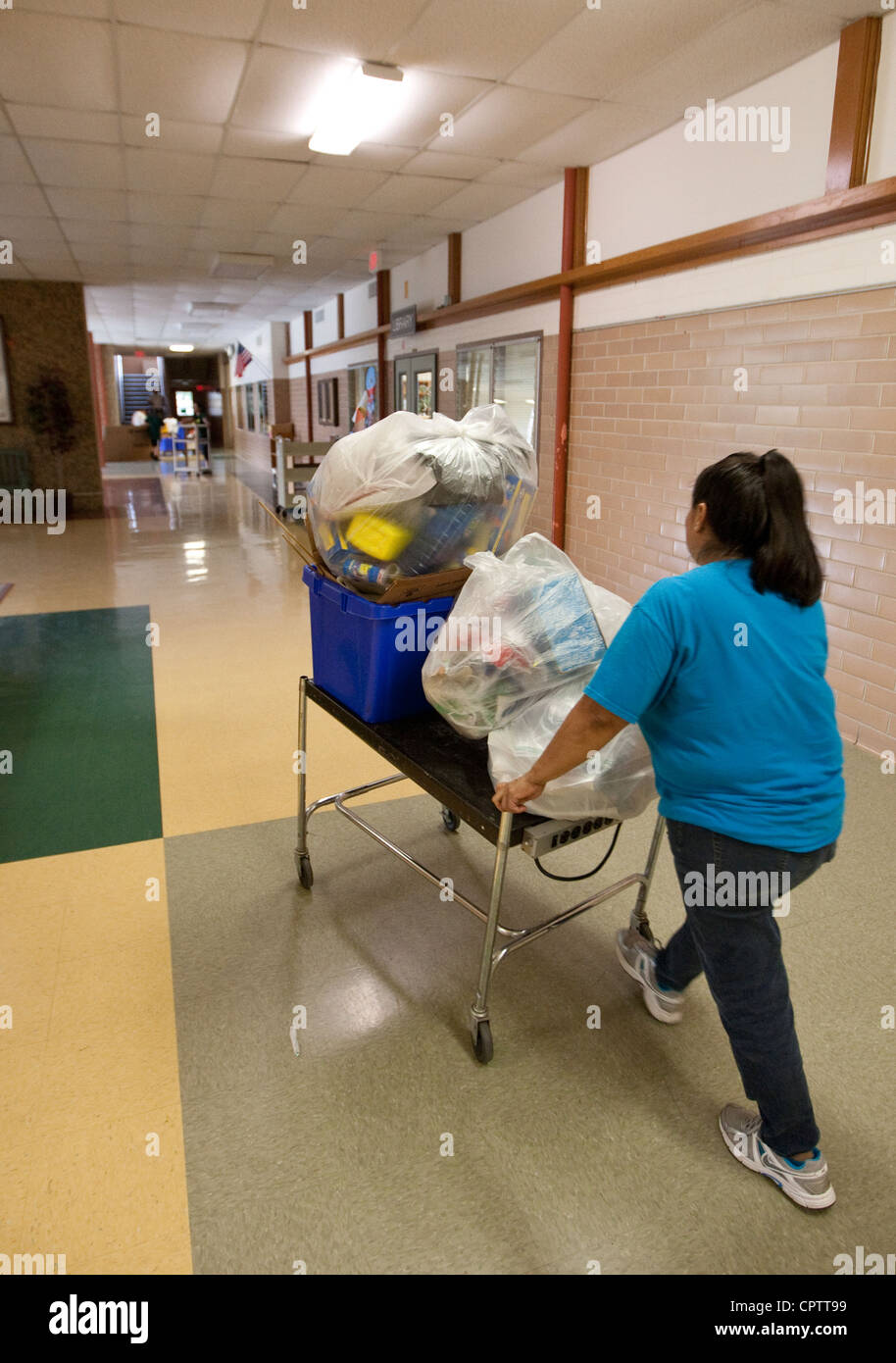 Teachers, students and librarians help pack up materials. The ...