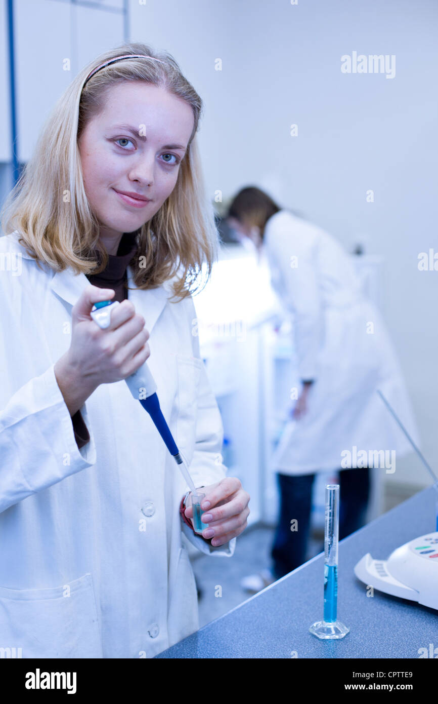 Closeup portrait of a female researcher carrying out experiments in a ...