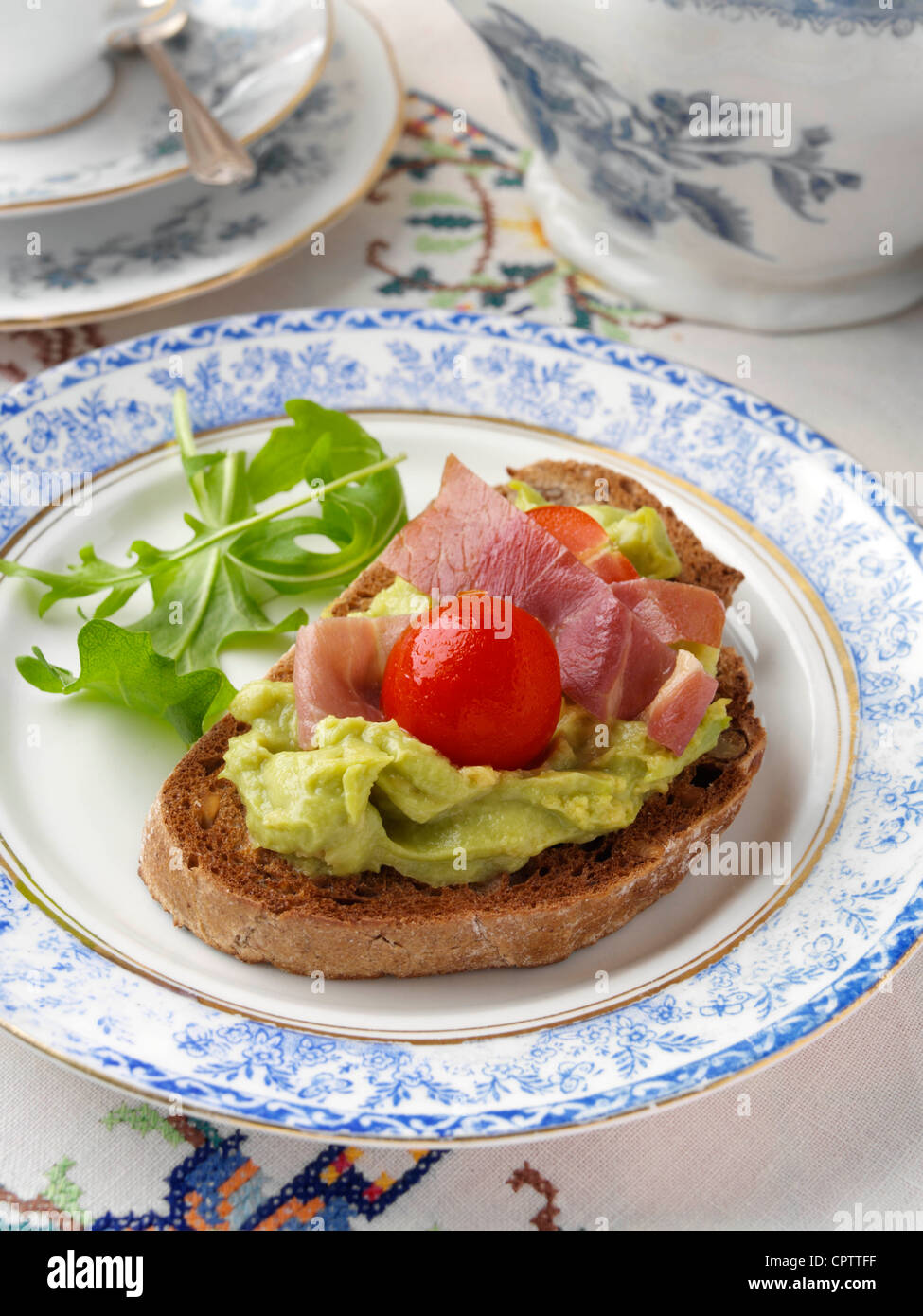 Bruchetta guacamole tomato parma ham finger food Stock Photo - Alamy