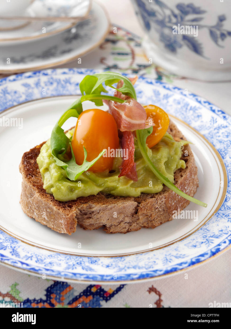 Bruchetta guacamole tomato parma ham finger food Stock Photo - Alamy