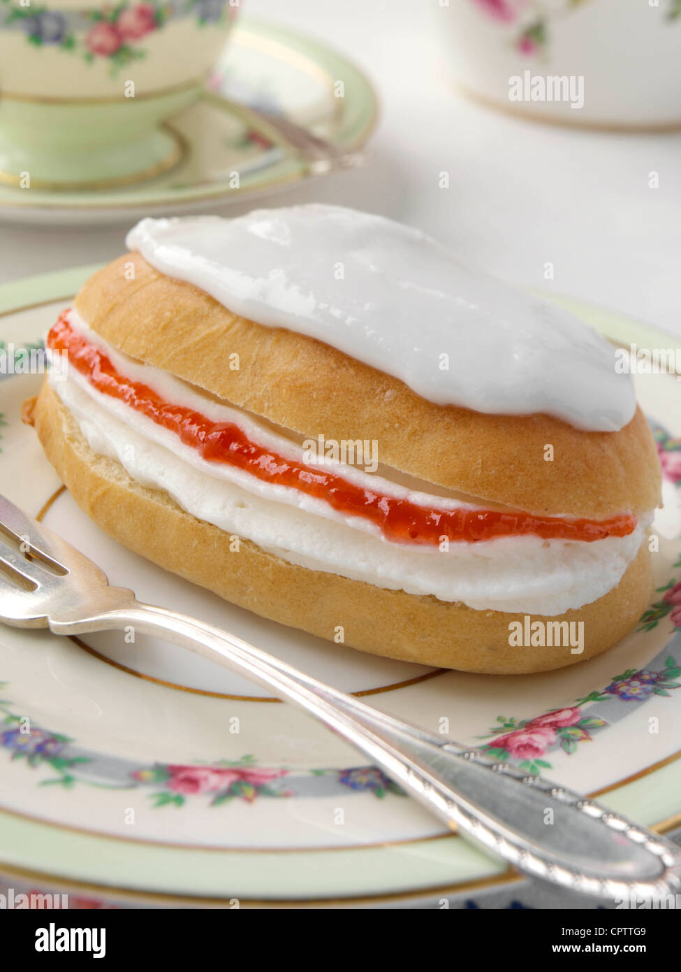 Individual strawberry jam cream filled iced finger bun hi-res stock ...