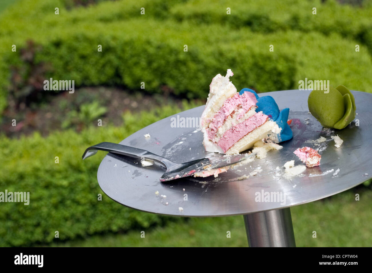 A piece of wedding cake on a stand in a garden Stock Photo - Alamy