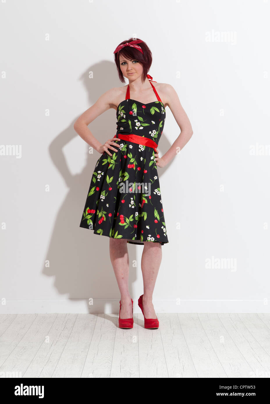 Colour photograph of female model posing within a studio environment ...