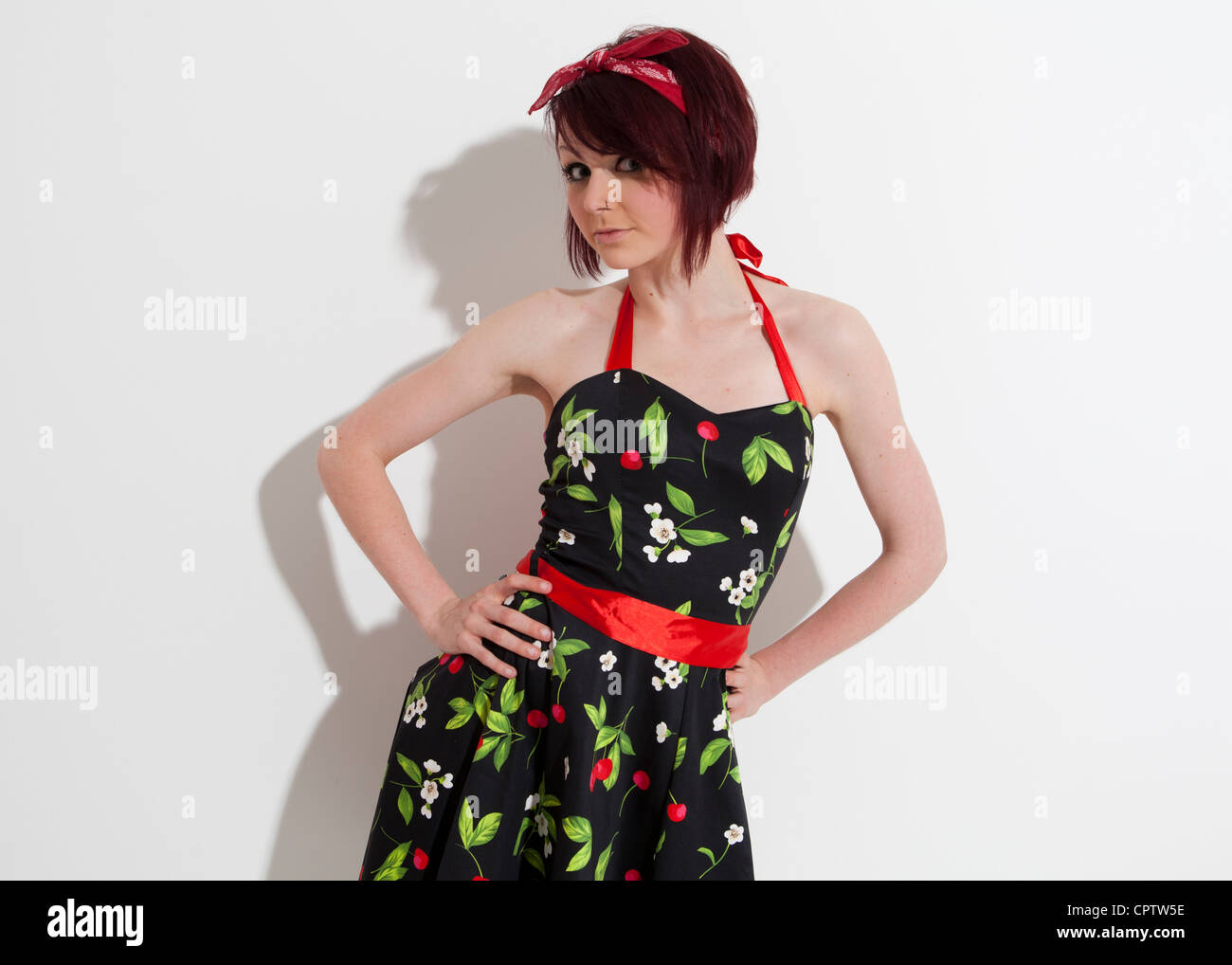 Colour photograph of female model posing within a studio environment ...