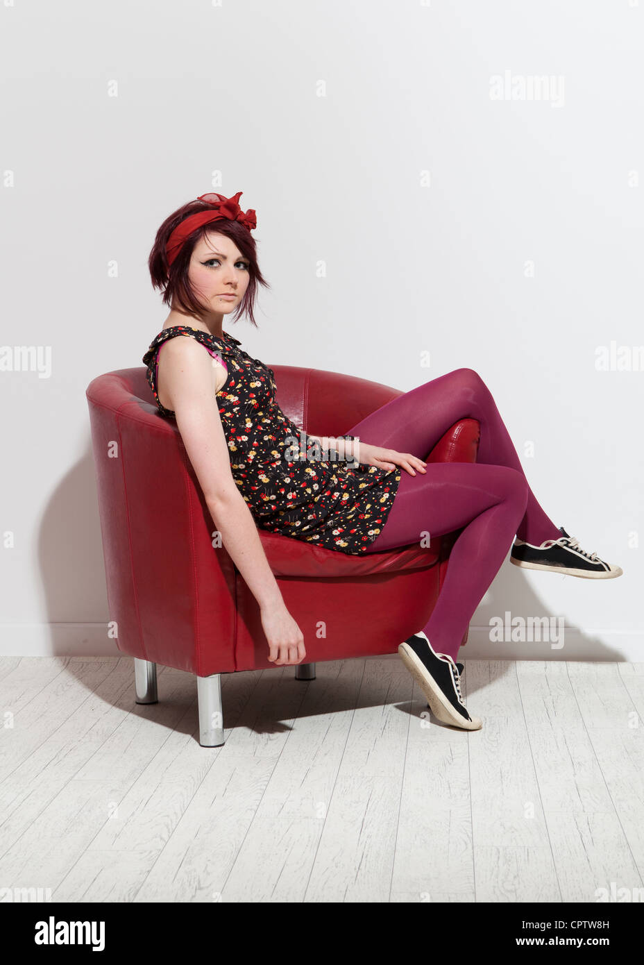 Colour photograph of female model posing within a studio environment ...