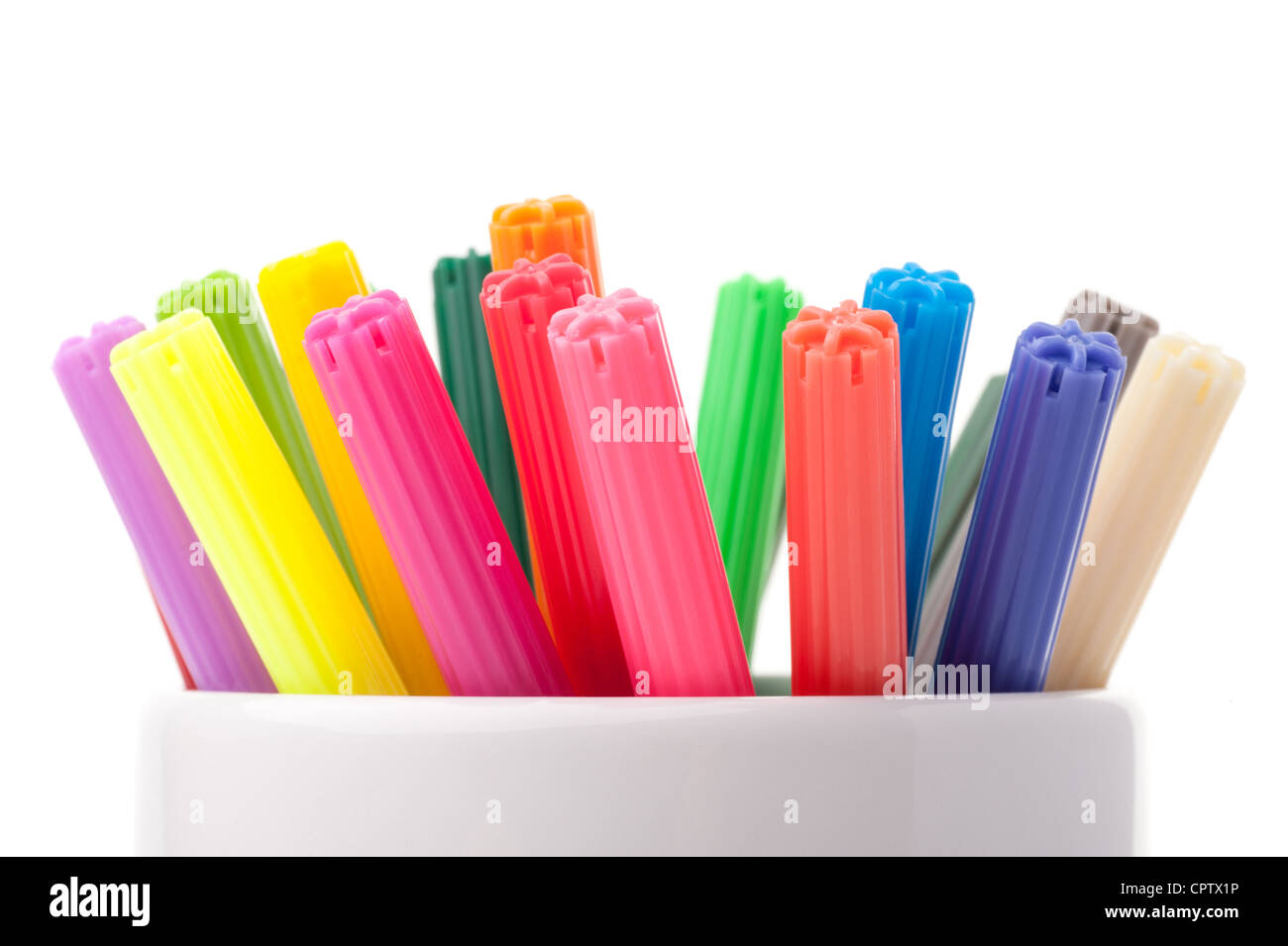 Group of color felt-tipped pens in a white cup, white background ...