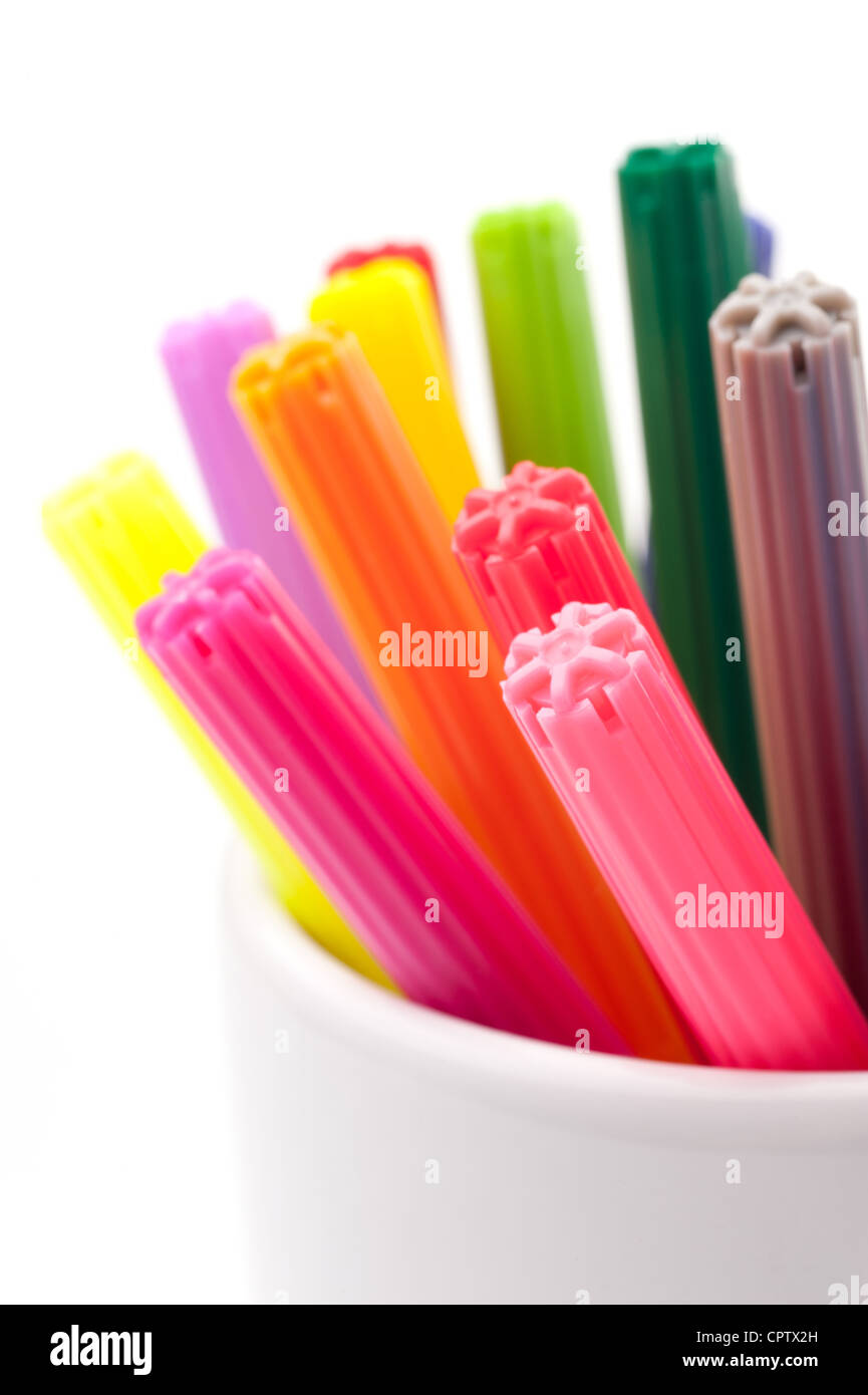 Group of color felt-tipped pens in a white cup, white background ...