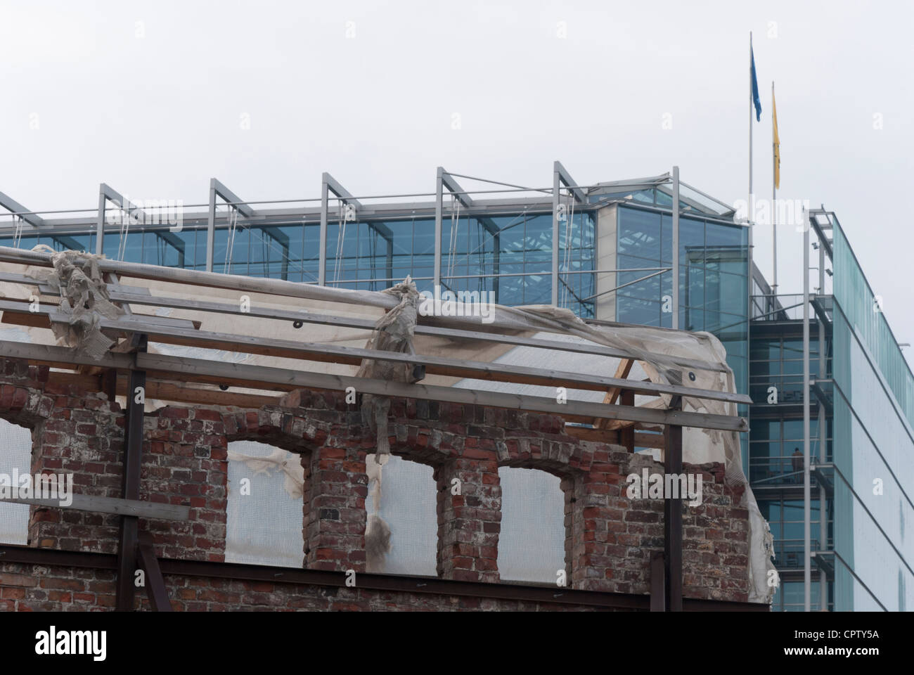 Sanomatalo office building behind the old brick wall in Helsinki ...