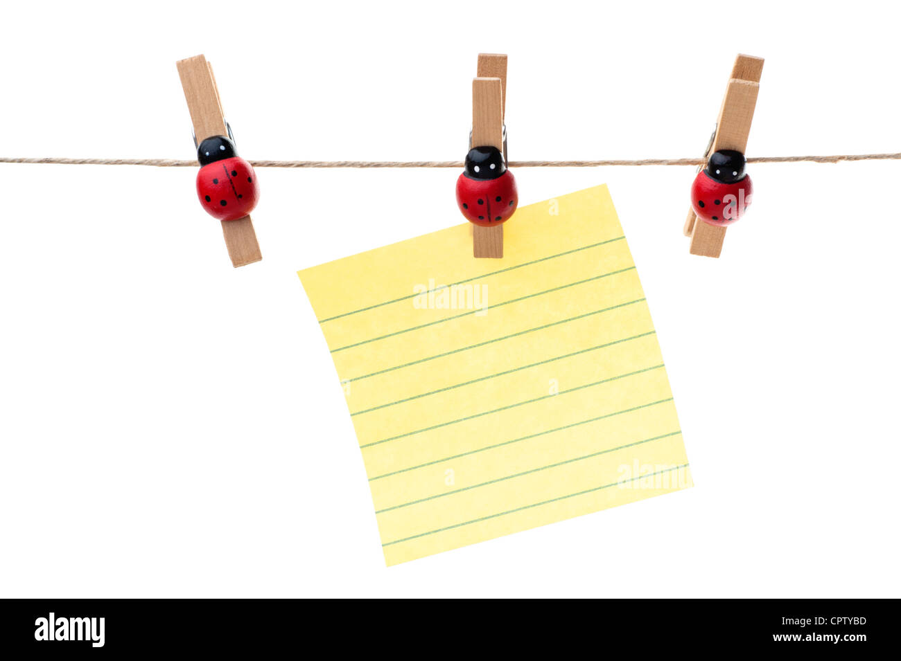 Yellow note hanging on a clothesline, three pins, white background ...