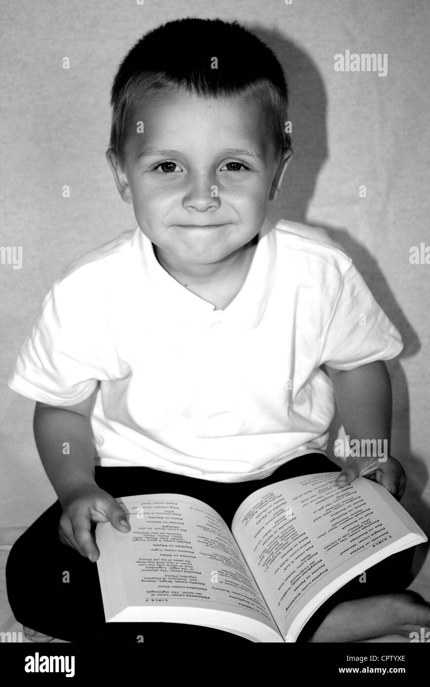 little boy is reading book Stock Photo - Alamy